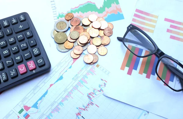 flat lay a glasses, money, calculator and chart or graph on office desk ...