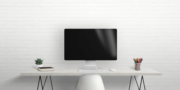 Computer monitor on work desk with brick wall in background. Blank ...