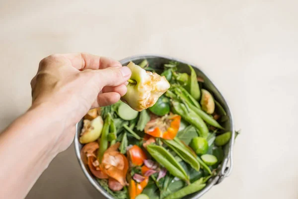 Throw organic waste into a compost bucket. Sorted organic kitchen waste ...