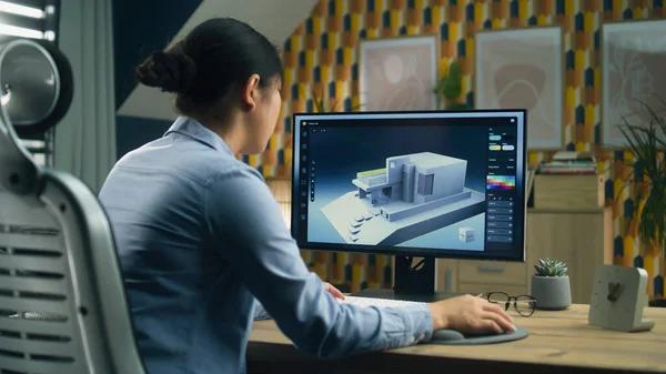 Female 3D designer at home working on 3D modeling project of house and ...