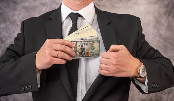 a man with a strong physique in a shirt and jacket holds his own earned ...