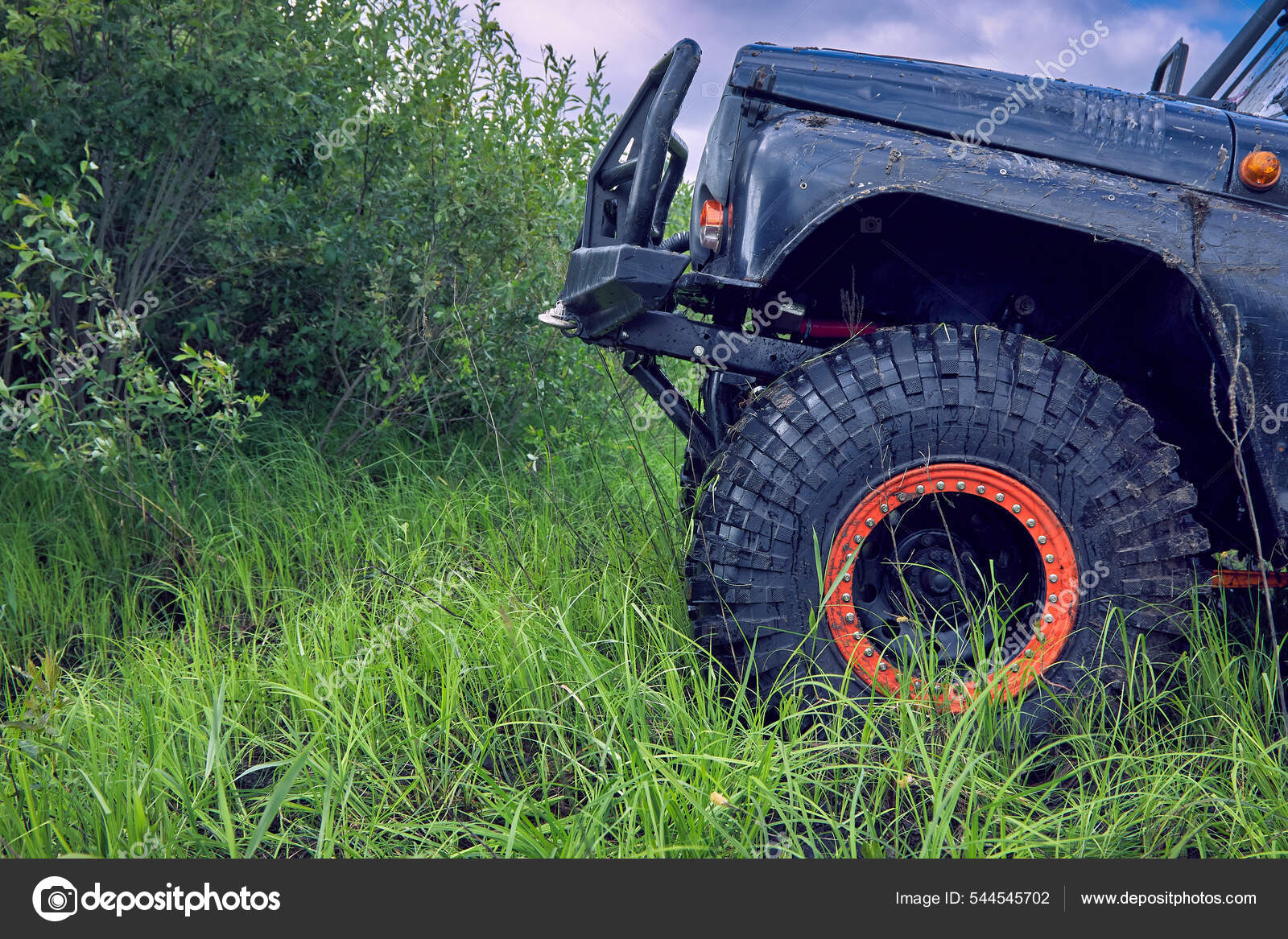 4x4 off-road car overcomes an obstacle going up the hill Stock Photo by ...