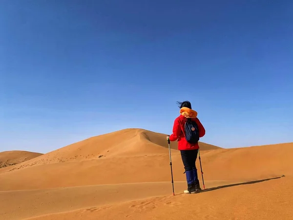 man in a red desert, sand dunes, a tourist trip to the namib of the ...