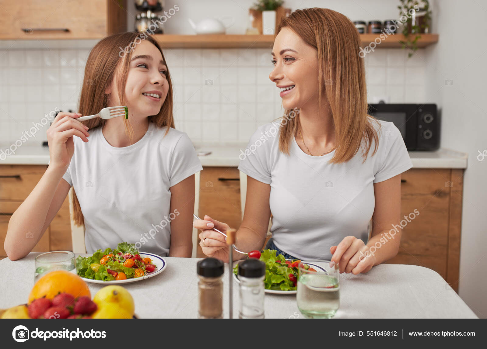 Mother and daughter eating lunch at home Stock Photo by ©kegfire 551646812