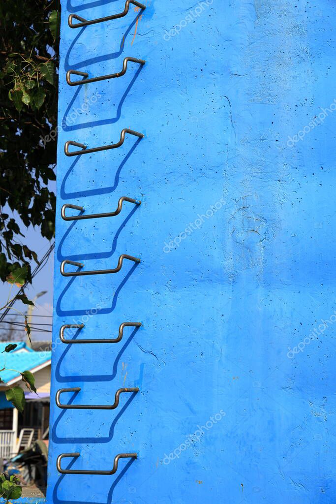 Ladder Going on the Upper Level of the blue Building. vertical metal ...