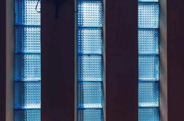 Old glass wall blocks in wall of a Soviet-style house. Scattered light ...