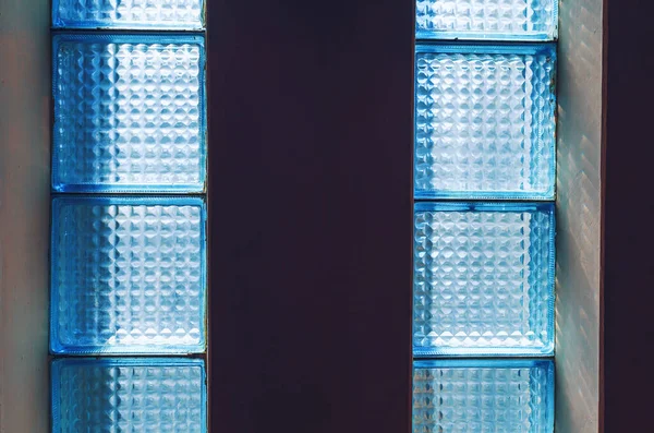 Old glass wall blocks in wall of a Soviet-style house. Scattered light ...