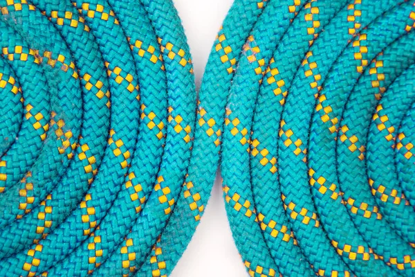 durable colored rope for climbing equipment on a white background. coil ...