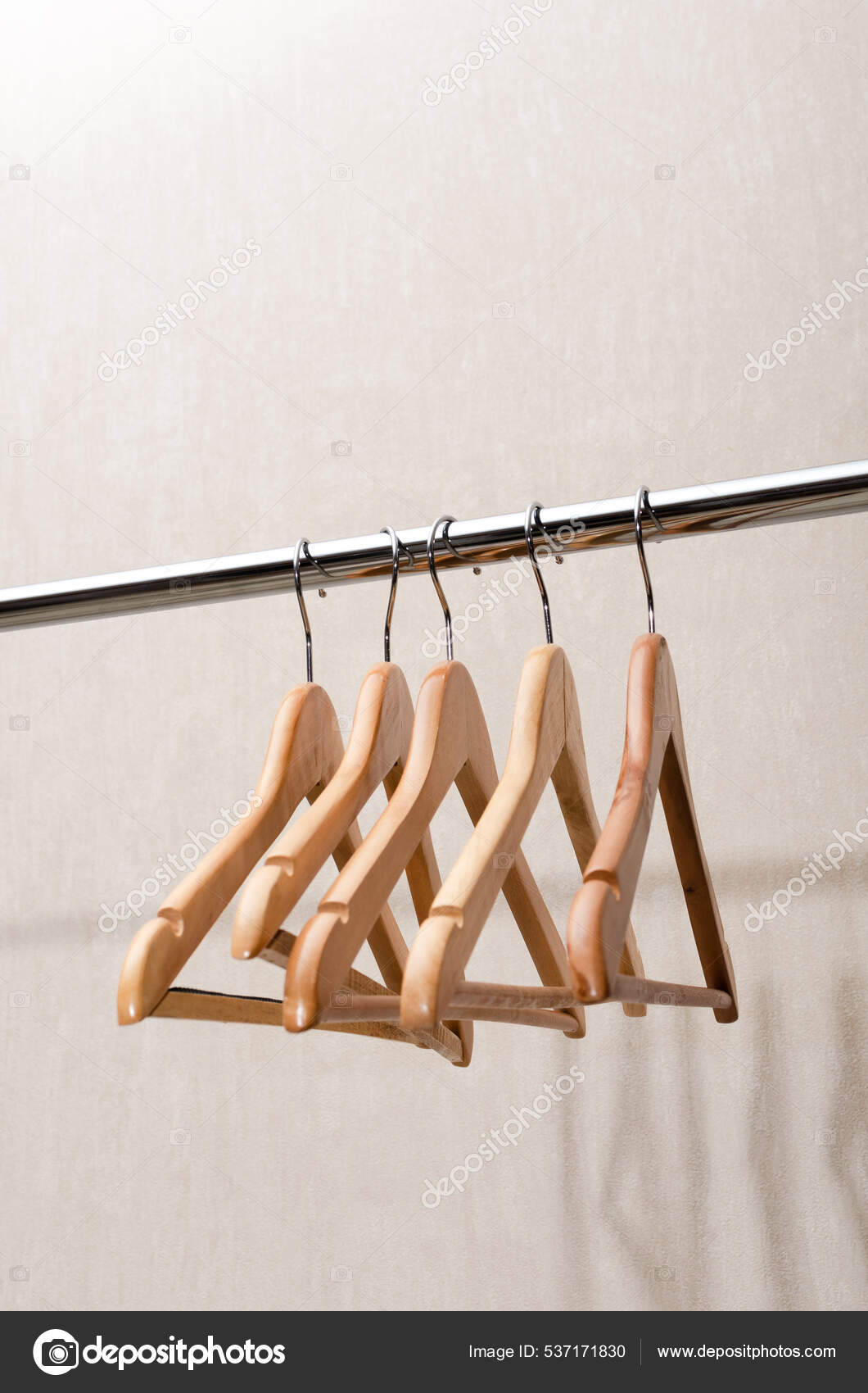 Empty clothes hangers on a shopping rail on a white background. Retail ...