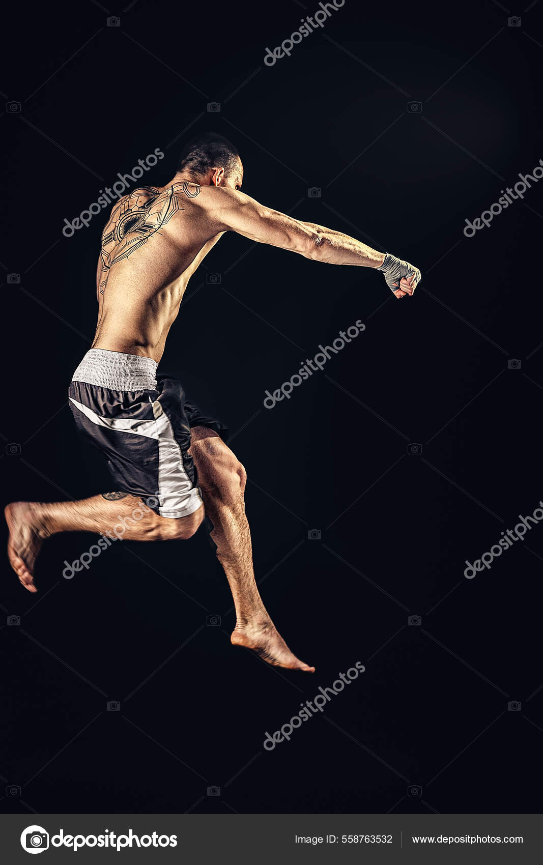 The professional athlete boxer in jump isolated on dsrk studio ...