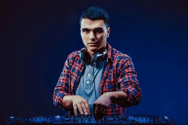 exicted dj sound device oprator with headphones by dancing at club ...