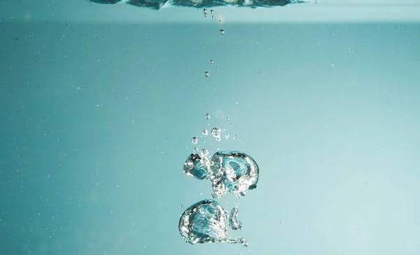 Clean bubbles inside water tank with blue in background closeup ...