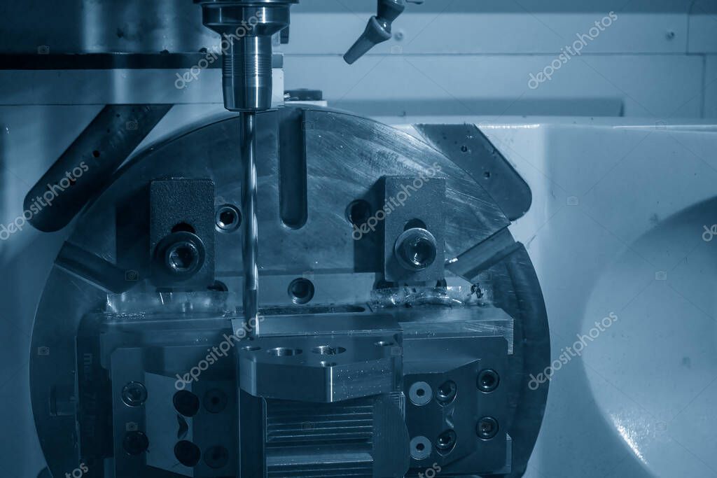 The 5-axis CNC milling machine hole cutting on the metal mold part. The ...