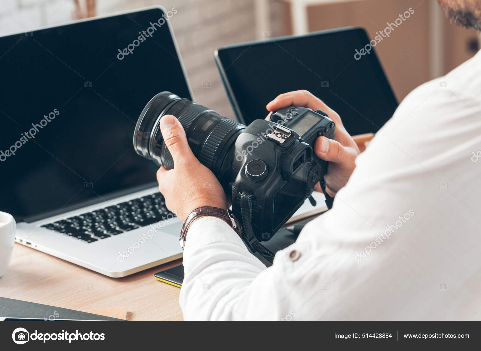 Young man photographer working on a computer. Work desk with keyboard ...