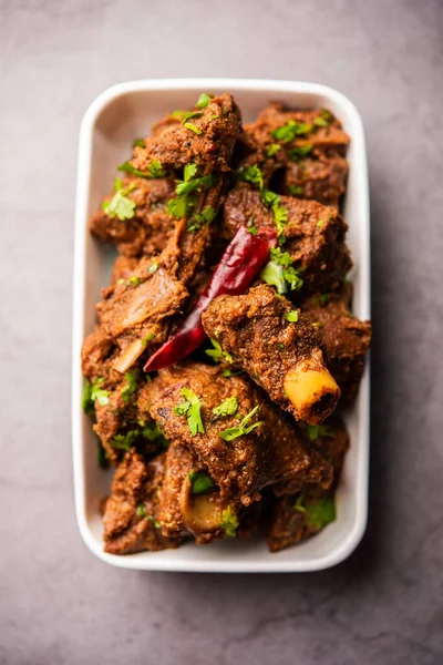 Sukha mutton or chicken, dry spicy Murgh or goat meat served in a plate ...