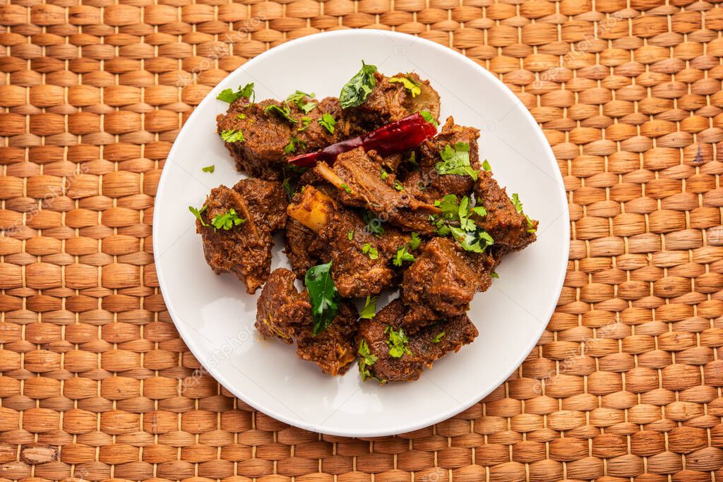 Sukha mutton or chicken, dry spicy Murgh or goat meat served in a plate ...