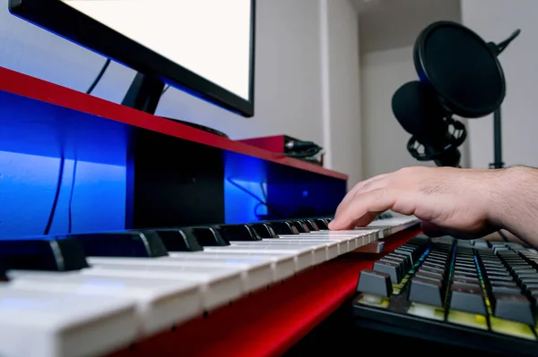close up side view of male caucasian hands playing electric piano in ...