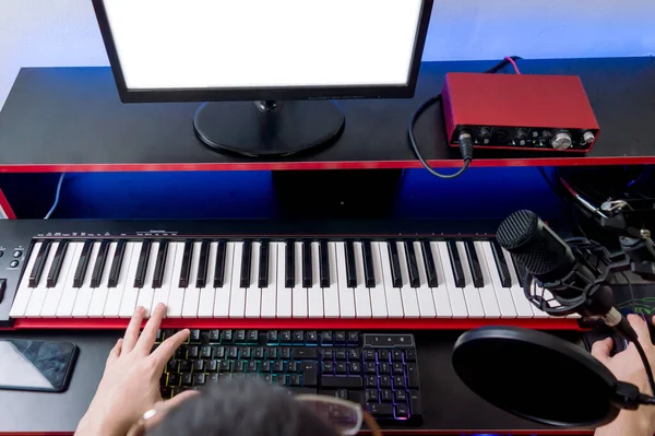 overhead view music producer at work mixing urban pop music at home ...