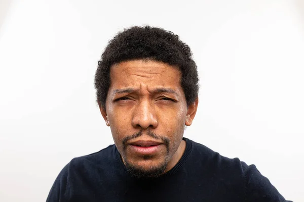 Myopic man without glasses straining his eyes because he can't see well ...