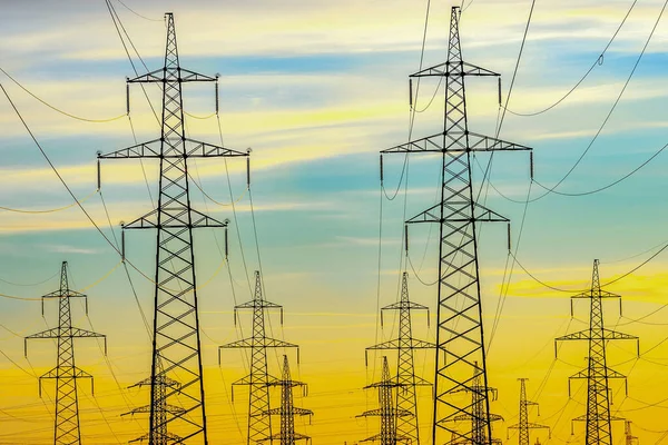 High-power electric poles at sunset. Power supply, power transmission ...