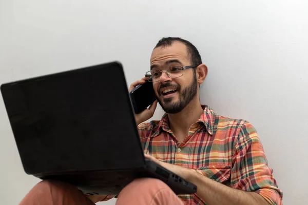 Latin American man with his laptop computer is a programmer and ...