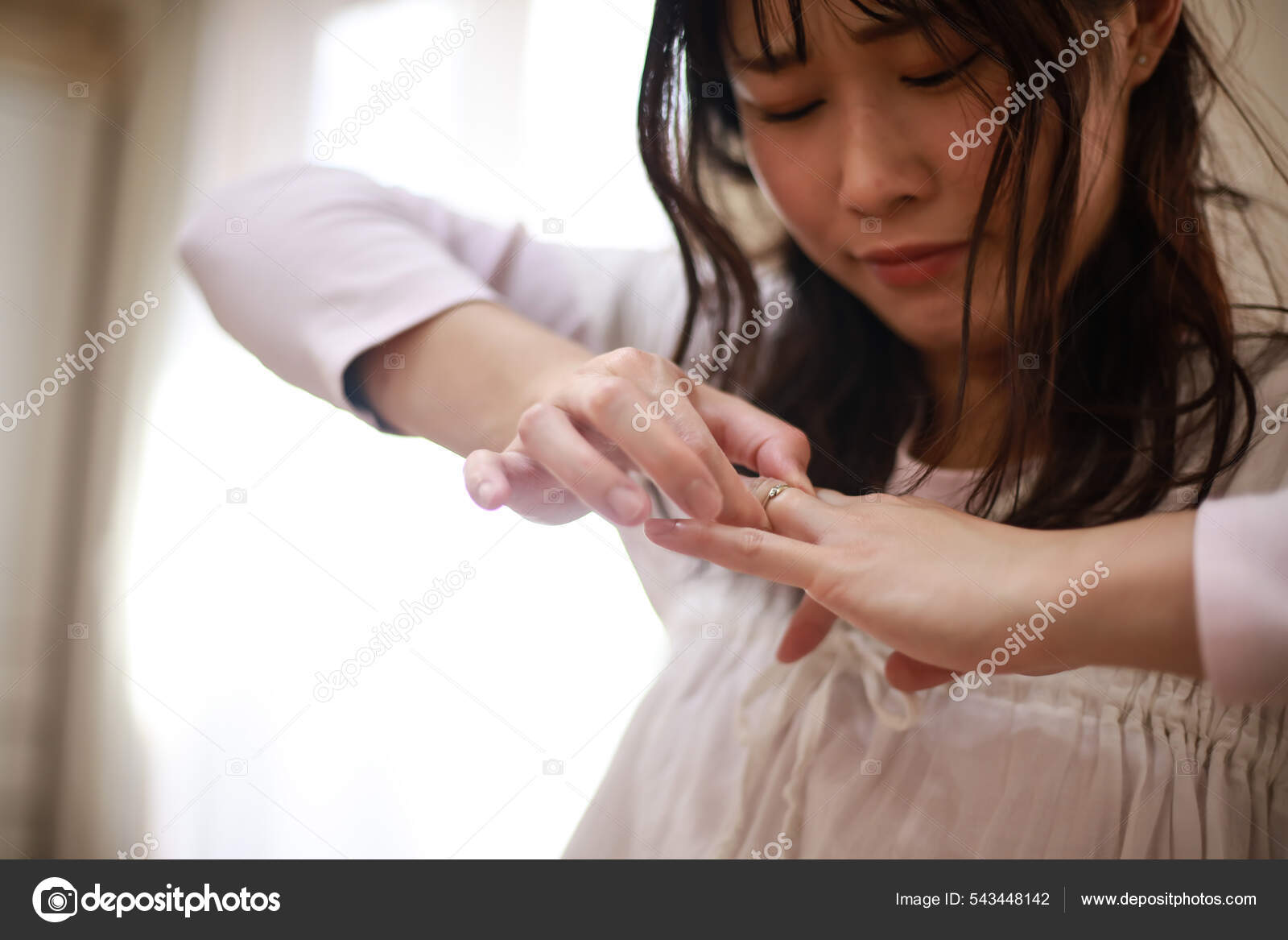 Young Asian Woman Removing Ring — Stock Photo © yamasan #543448142