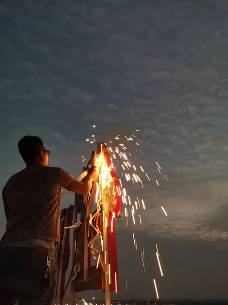 man with fire torch at the roof of the building - Stock Image - Everypixel