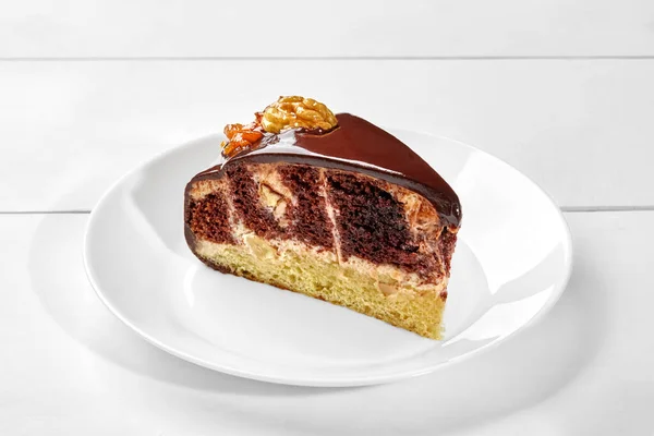 Slice of tender cake with layers of vanilla and cocoa biscuit with sour ...