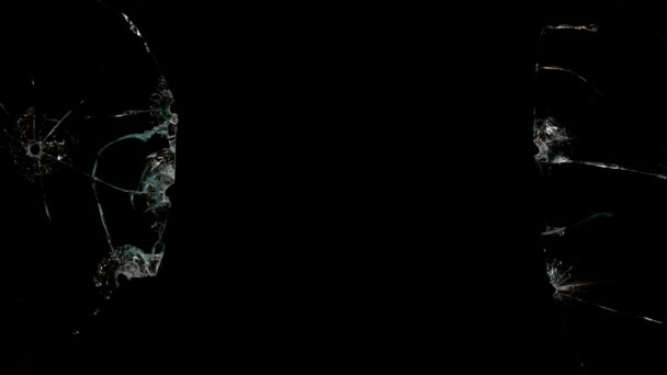 Fragments of broken glass fly in different directions on a black ...