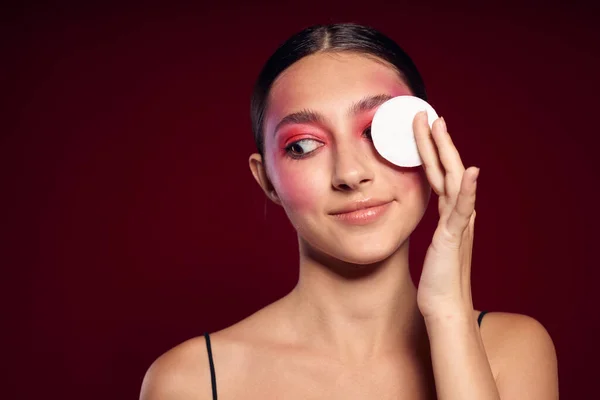 Young beautiful woman pink face makeup posing attractive look skin care ...