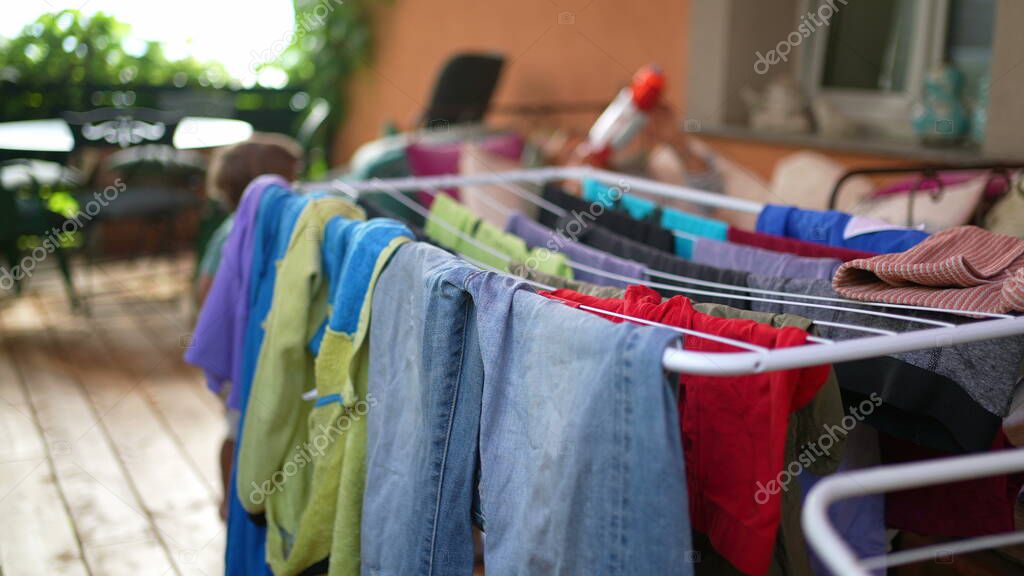 Drying of colourful clothes. Laundry drying racks 2022