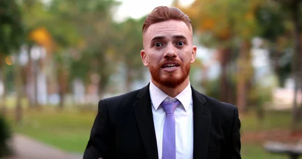 Angry business man standing arguing to camera outside. Upset executive ...