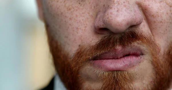 Upset man snarling close-up eyes and mouth. Redhead red beard grimacing ...