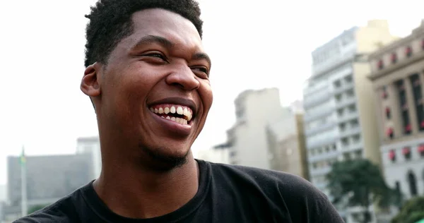 African black man smiling and laughing outside, real authentic people ...