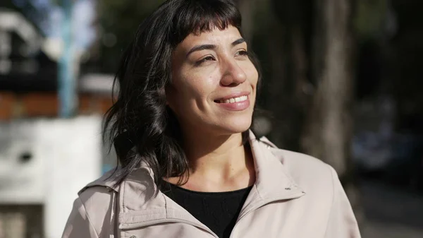 Happy person jumping in the air celebrating achievement. A young latina ...