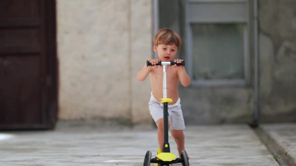 Child Riding Three Wheeled Scooter Shirtless — Stock Video ...
