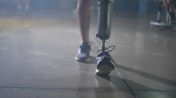 Disabled person walking with his prosthetic leg indoors. Amputee man ...