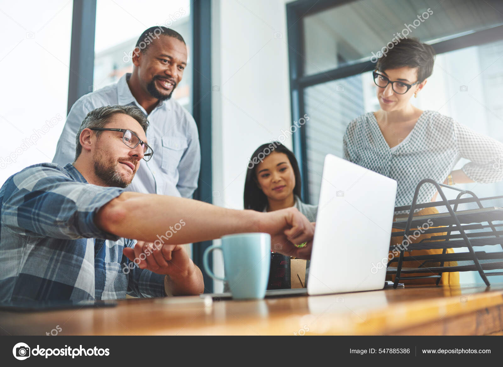 Working together to get the task done. Shot of businesspeople working ...