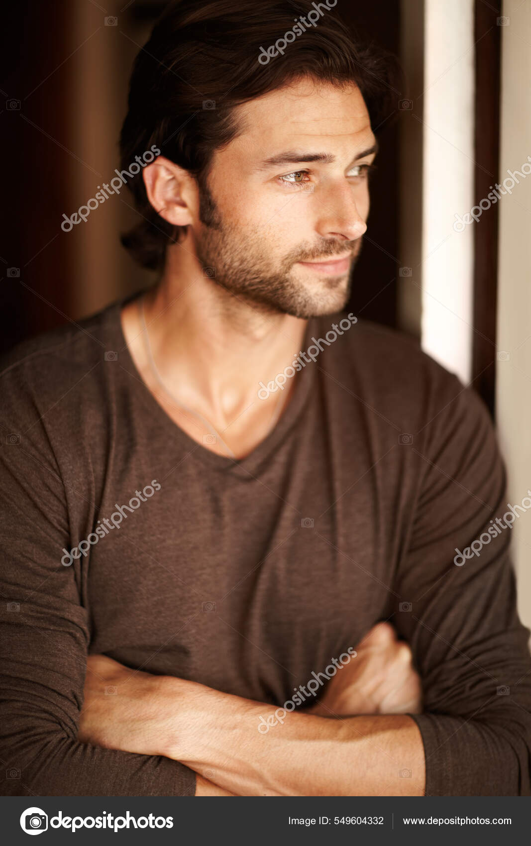 Content with his lot in life. A handsome young man gazing out of a ...