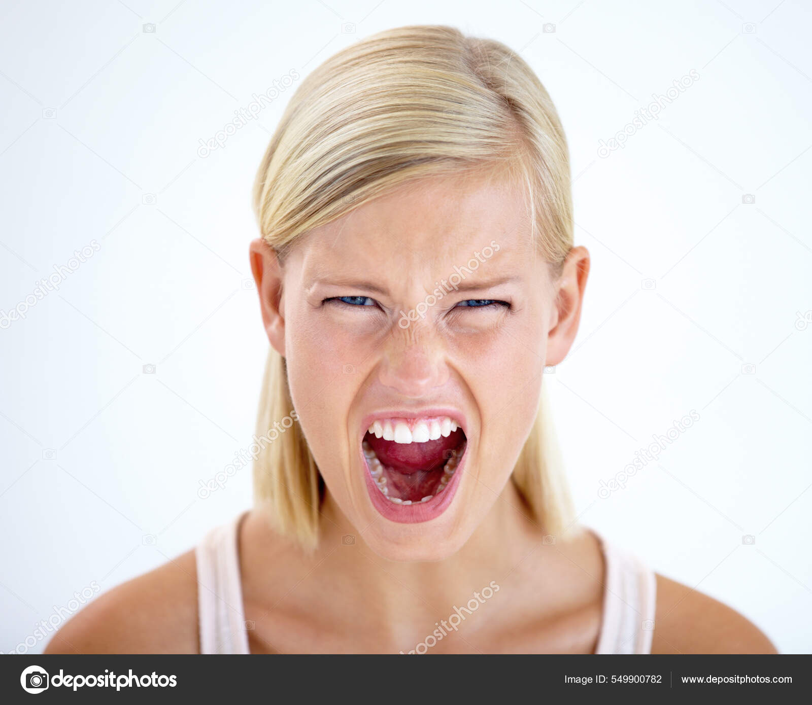 RAGE. Head and shoulders portrait of a furious woman screaming loudly ...