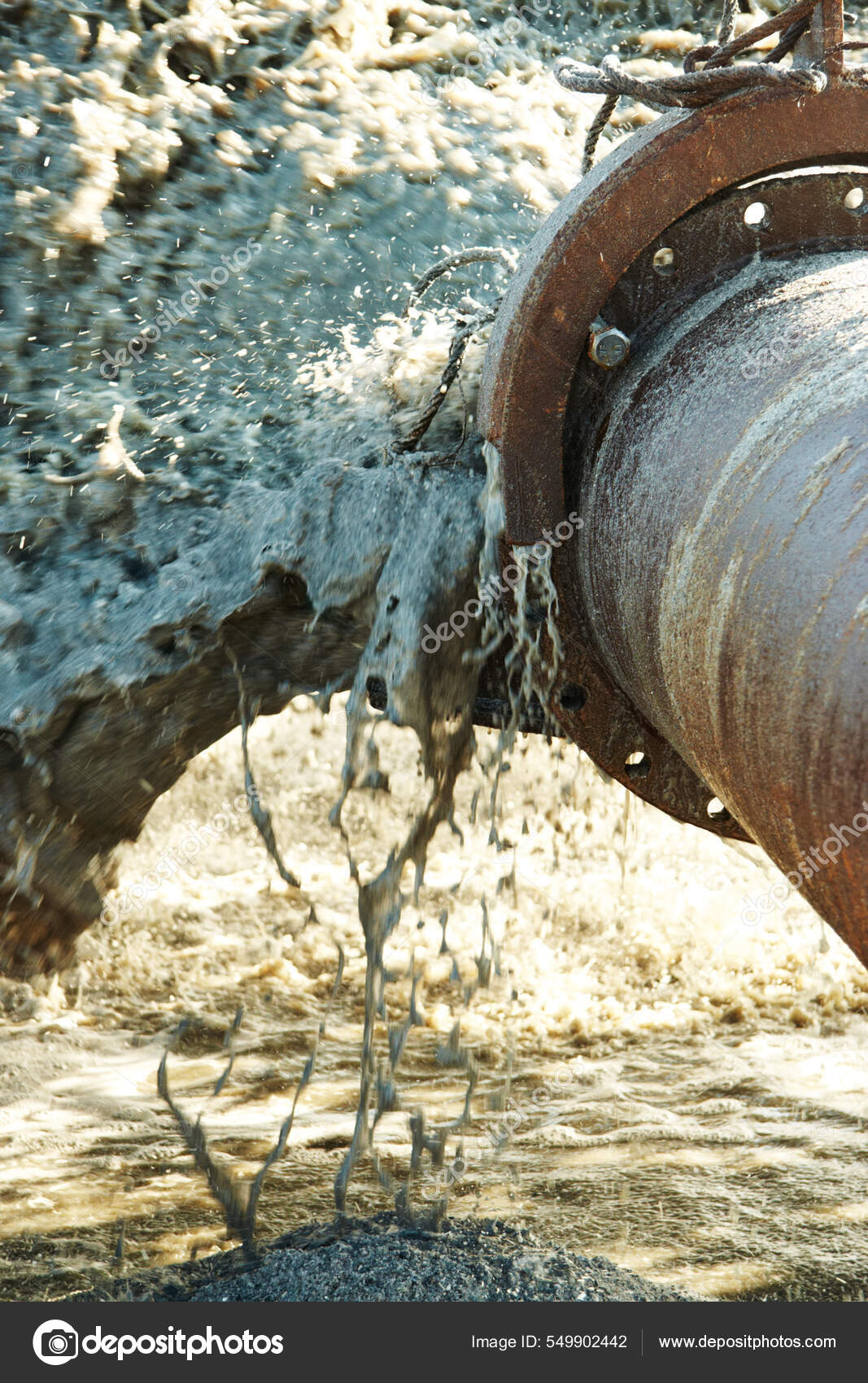 Pollution in the pipelines. Pipeline with polluted liquid gushing out ...