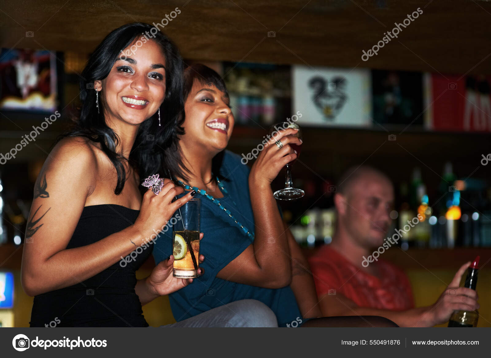 Out on the town. Two beautiful young girls out partying together and ...