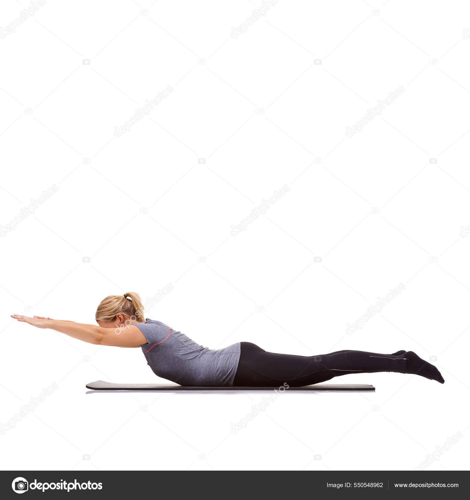 Toning up her muscles. A young woman exercising on a yoga mat. Stock ...