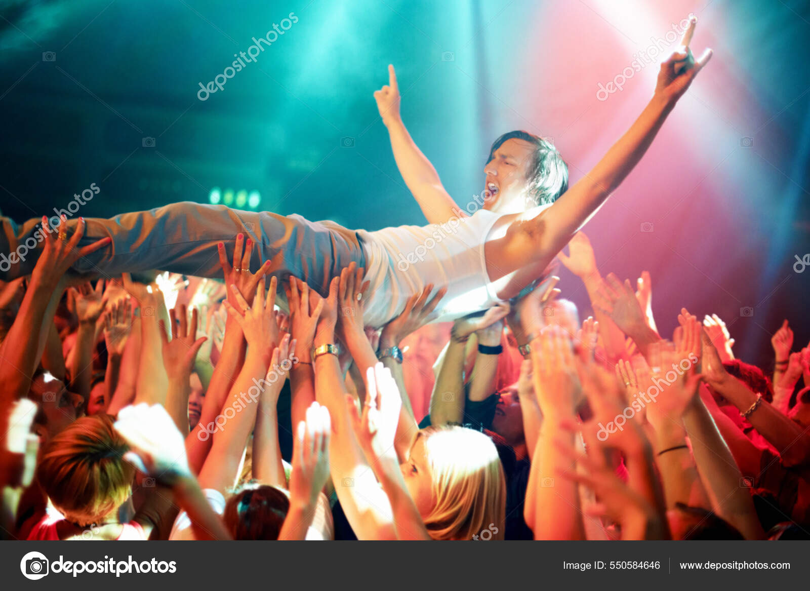 A young man cheering as he crowd surfs at a concert. This concert was ... A young man cheering as he crowd surfs at a concert. This concert was ...