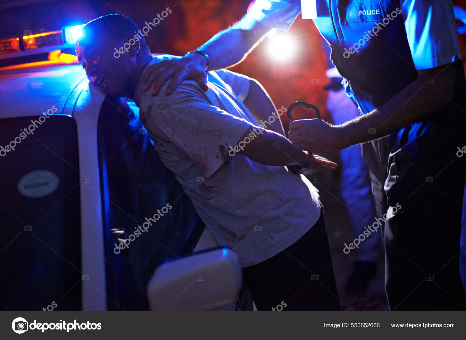 To Serve And Protect Shot Of A Police Officer Handcuffing A Suspect