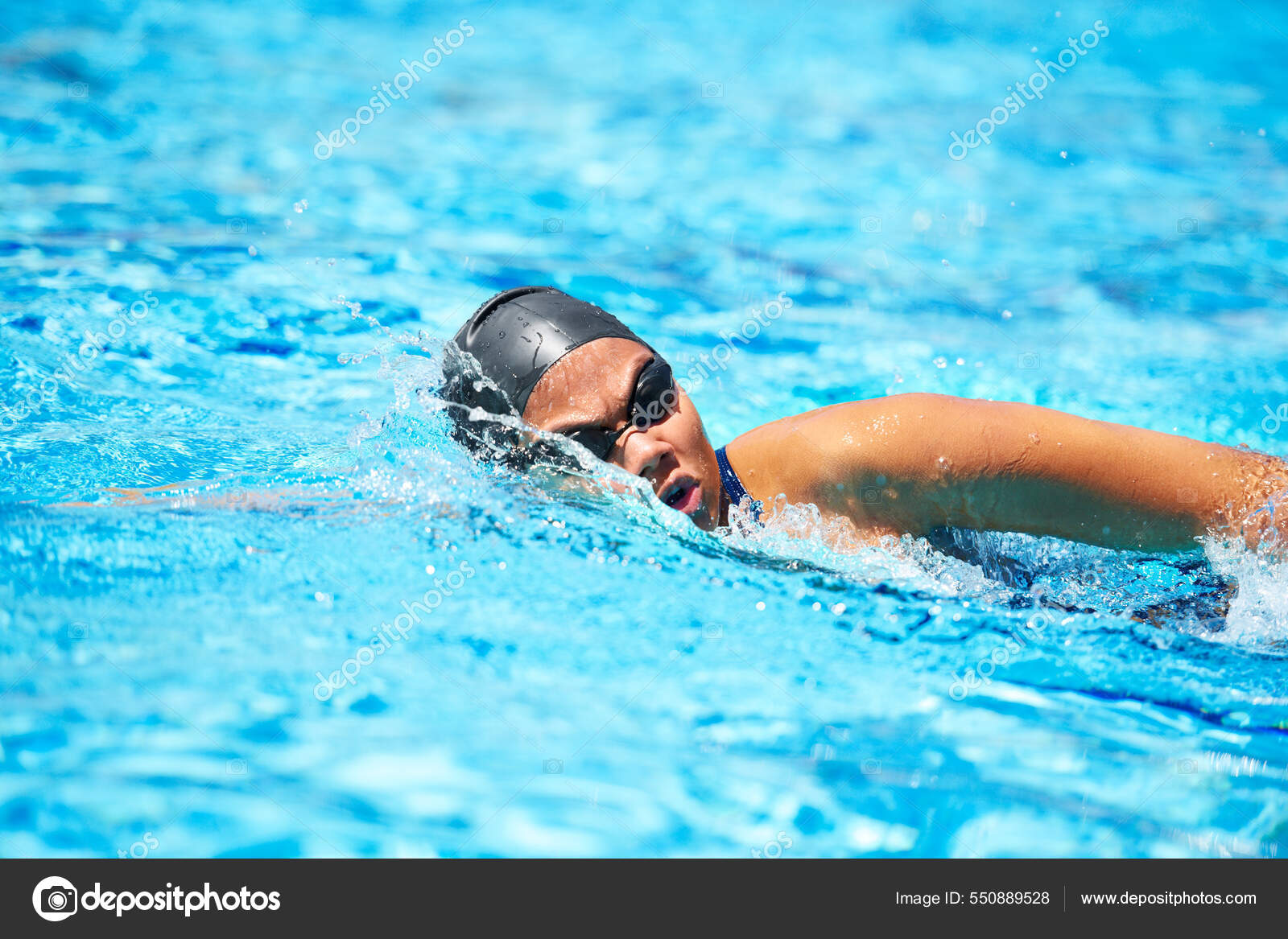 Training to be the best. Female swimmer making her way through a ...