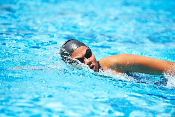 Taking her swimming seriously. Female swimmer making her way through a ...