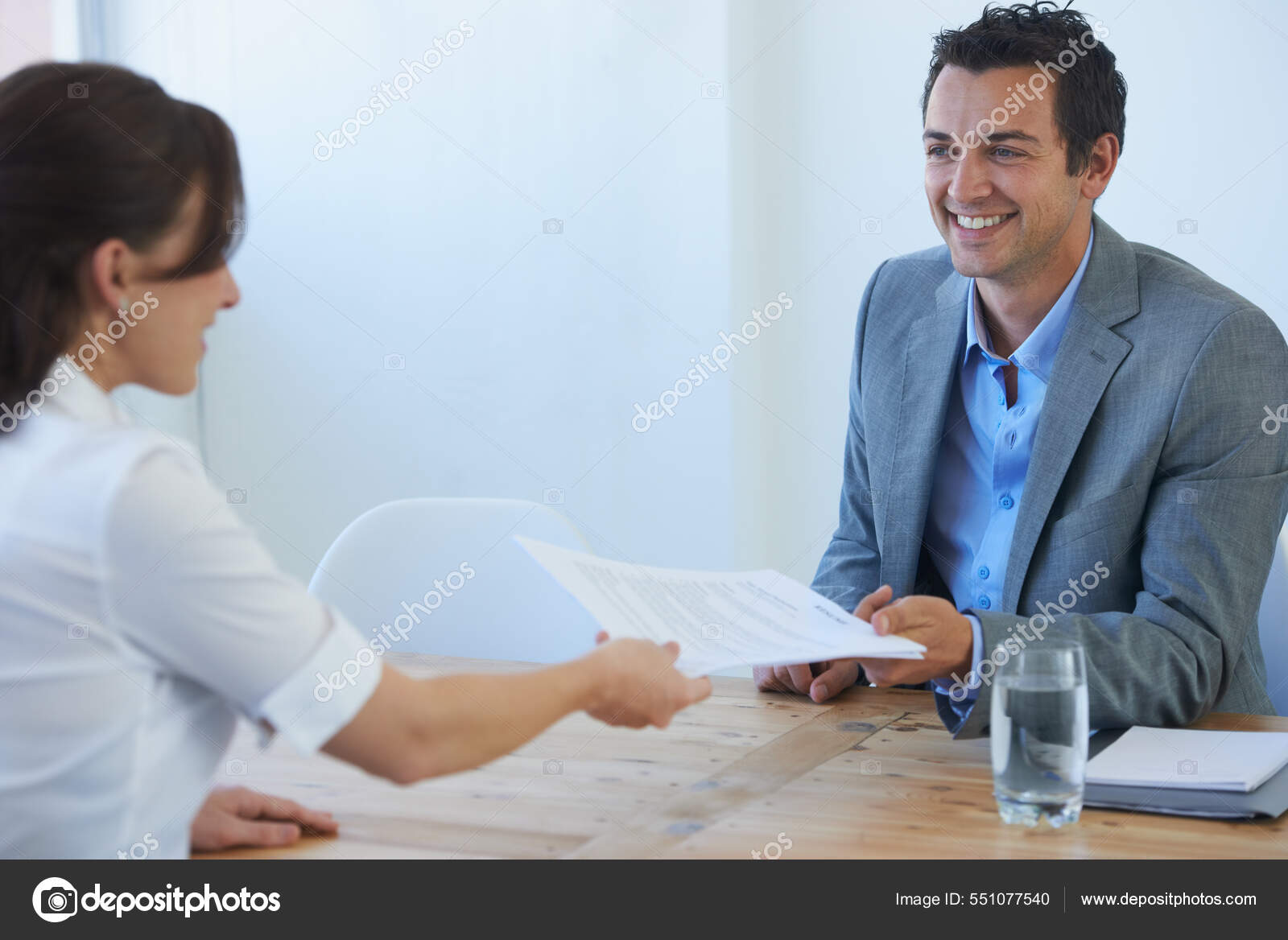 Handing him her resume. A pretty young woman handing her resume to a ...