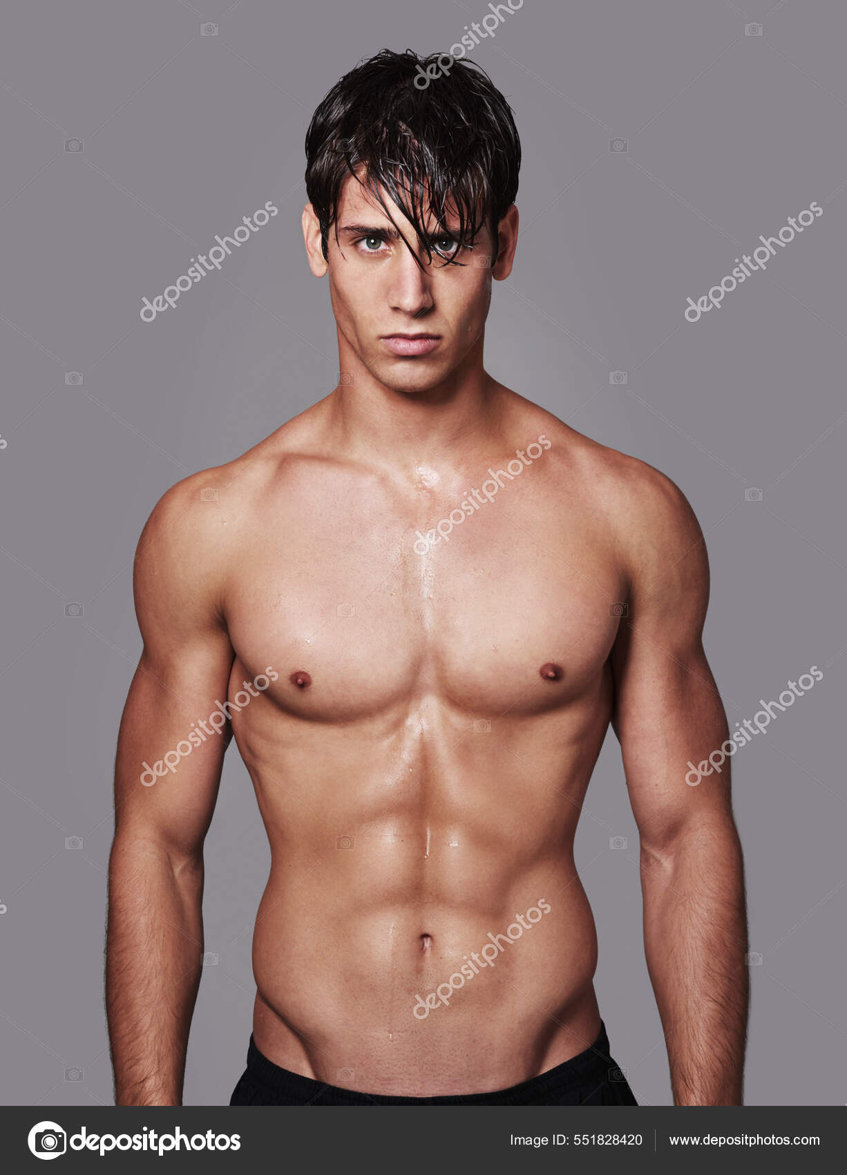 Hes one chiseled dude. A handsome young shirtless man posingPortrait of ...