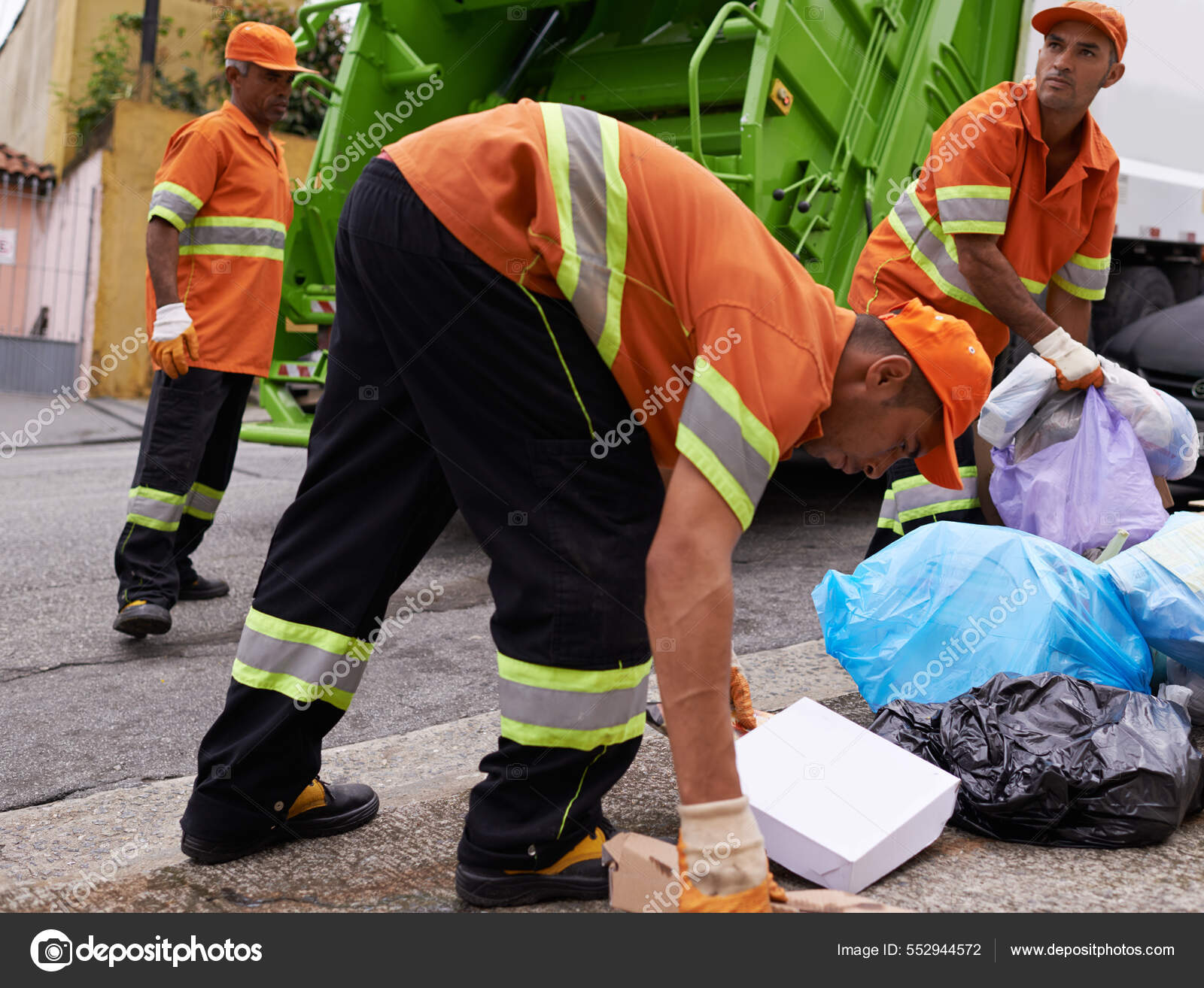 Keeping the city clean. Cropped shot of a team of garbage collectors ...